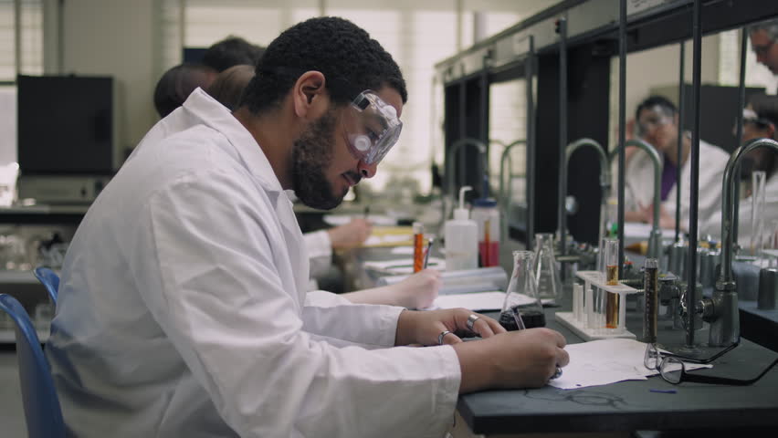 Stock Video Clip of A student observing his science experiment and ...