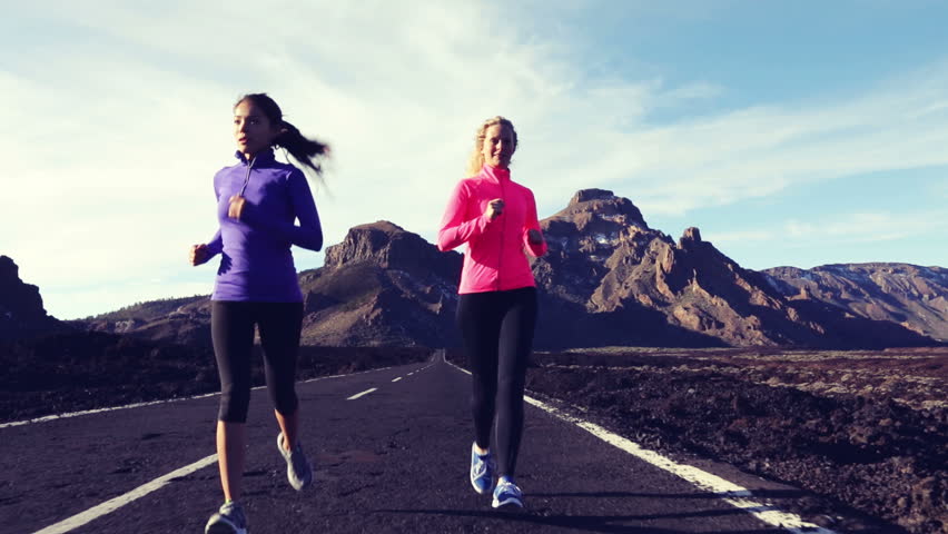 Running Sport Athletes Woman And Man Jogging At Night Sunset. Runners ...