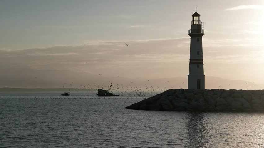 Lighthouse And Breakwater With Fishing Boat Moving In The Sea With ...