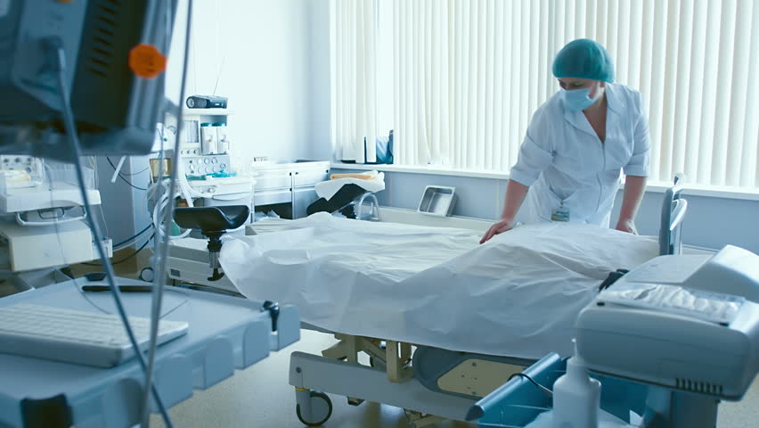 A Doctor Is Preparing A Pregnant Woman Lying In The Medical Bed In The ...