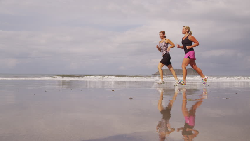 Women Running On Beach, Slow Motion. Shot On RED EPIC For High Quality ...