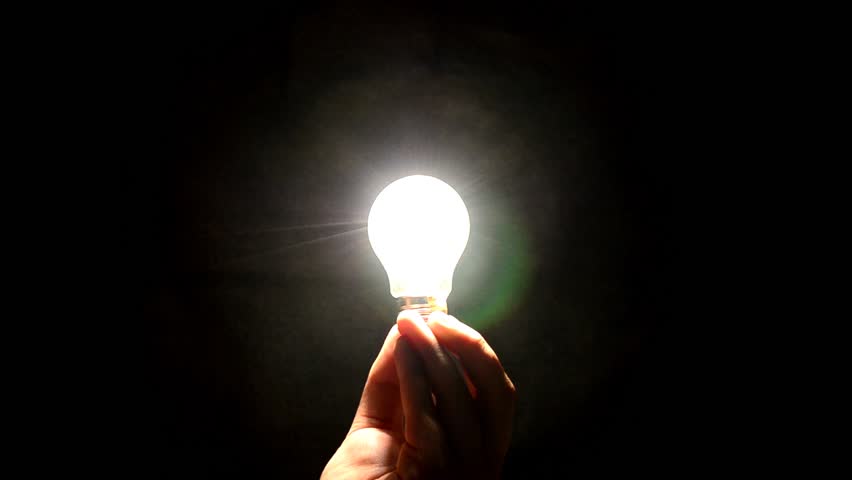 Stock Video Clip of hand holding a light bulb in the | Shutterstock