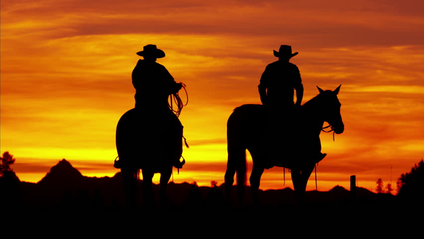Silhouette Reveal Of Cowboy Riders In Sunset Wilderness Canada ...