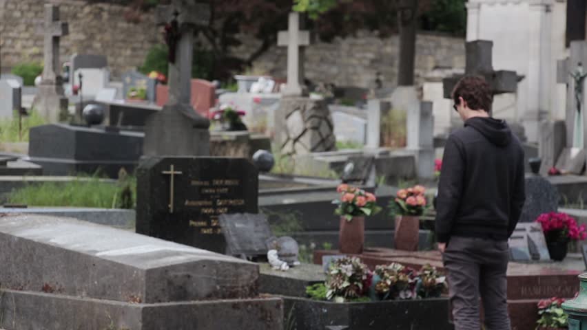 Man Crying In Tomb Of A Cemetery And Then Leaves. Desperate Young Man ...