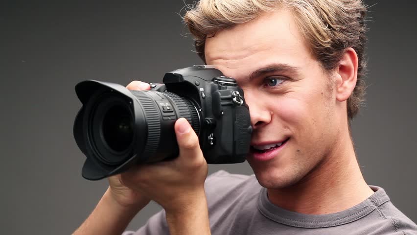 Stock Video Clip of Male photographer using a digital camera | Shutterstock