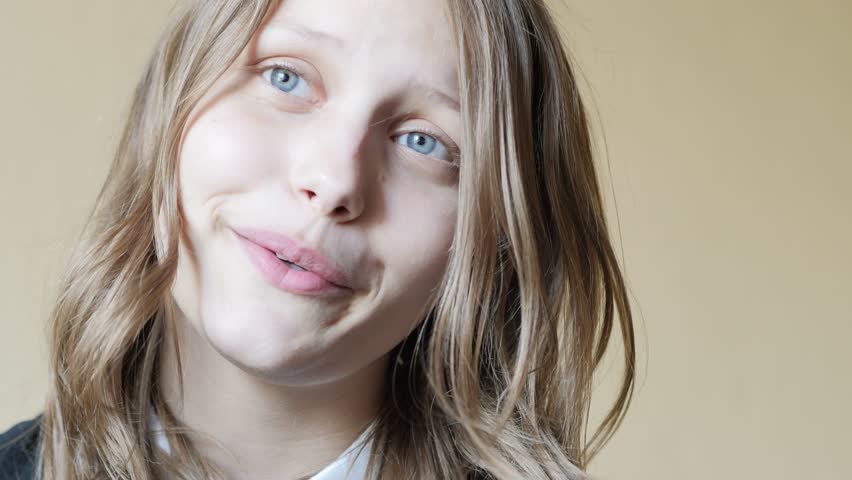 Girl Sits And Stares, Her Face Is Shown Close Up, Against Background ...