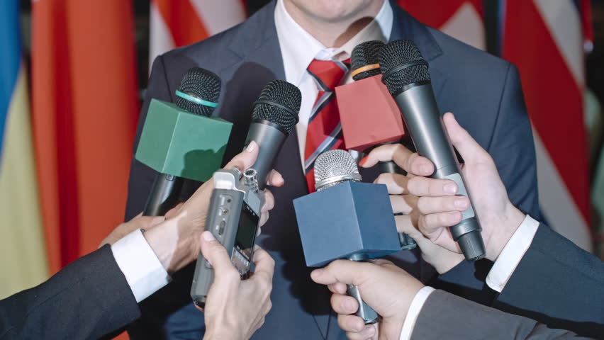 Medium Shot Of Politician Looking At Camera Giving Interview To ...