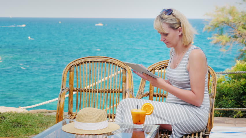 Young Woman Drinking Coffee. Sitting On The Terrace Overlooking The Sea ...