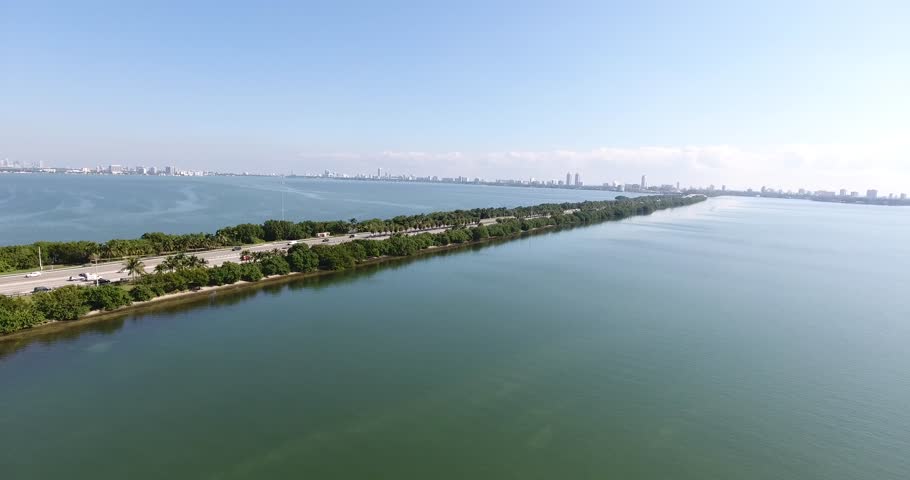 Aerial Ascending View Of The Asphalt Road Over Water By The Lake ...