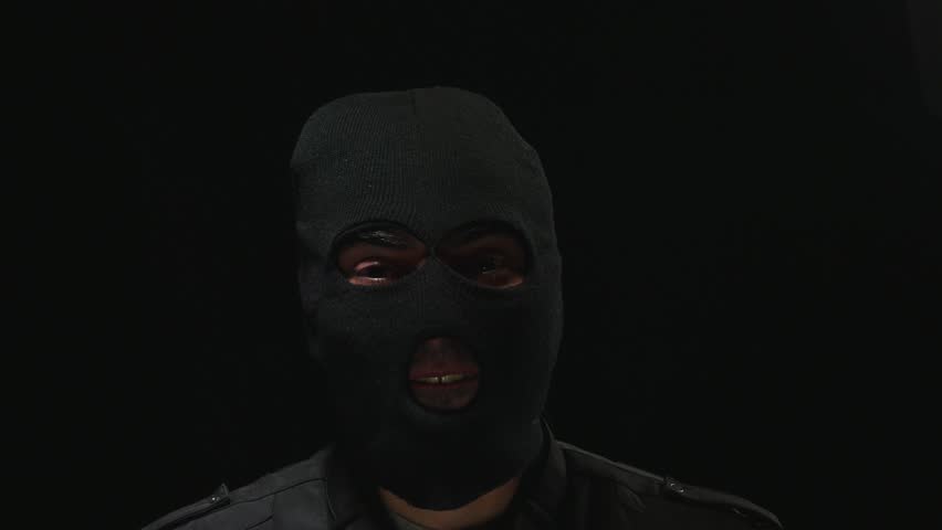 A Masked Man, Robber, Criminal, Appears From Deep Darkness And Comes ...