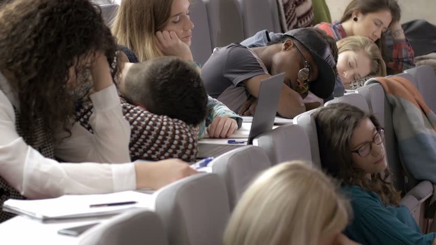 Student Asleep At Desk In Lecture Hall At The University Videos de ...