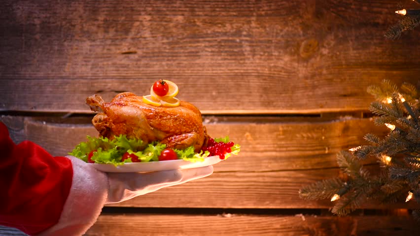Christmas Holiday Dinner. Santa Claus Hand Holding Roasted Chicken ...