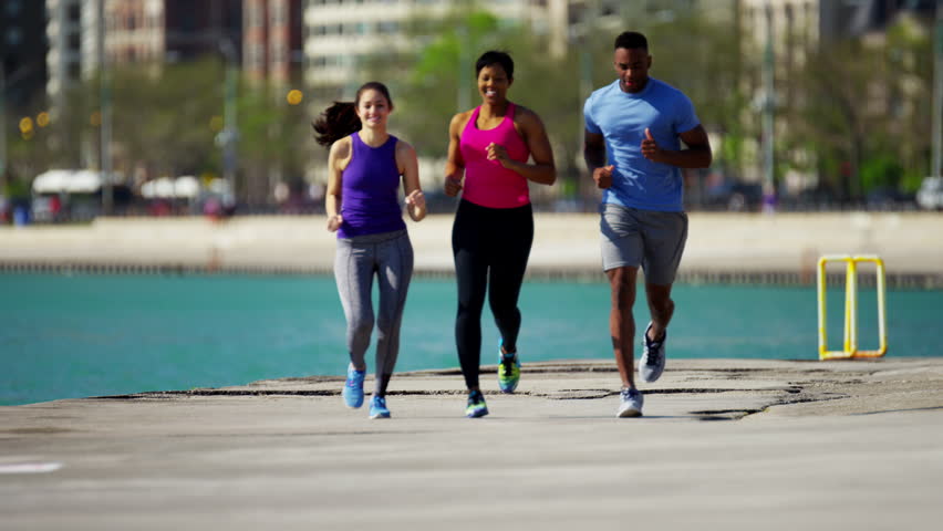 Happy Fun Loving Group Of Friends Running, Jumping And Diving Into ...