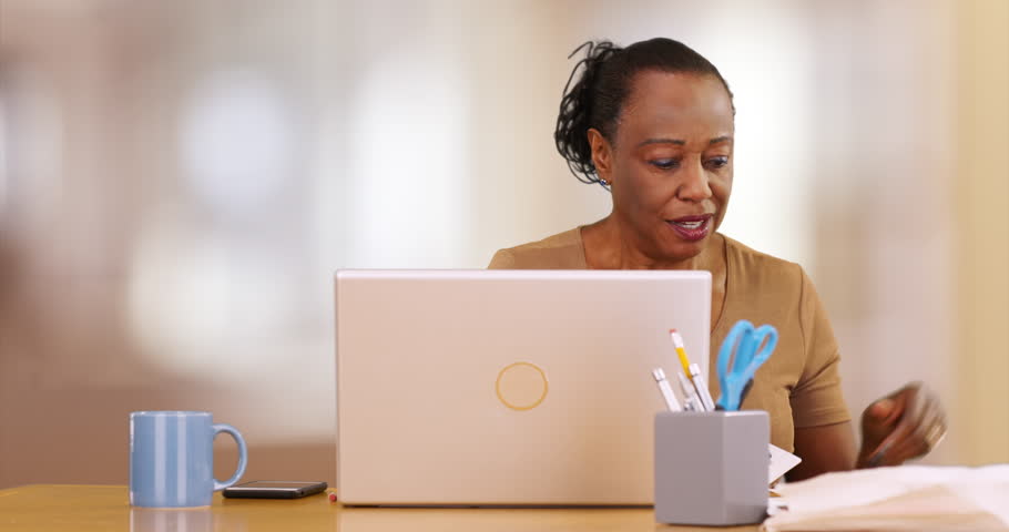 Black Senior Woman Talking Smartphone And Using Computer Stock Footage ...