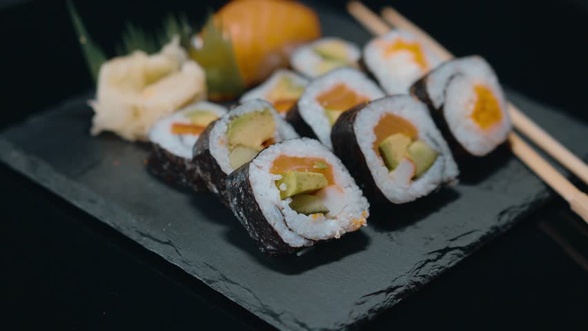 Sliced Sushi Roll On Plate In Japanese Restaurant. Shot On RED Cinema ...