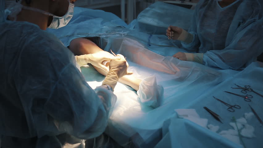 Surgeons Team Performing Operation In Hospital Operating Theater ...