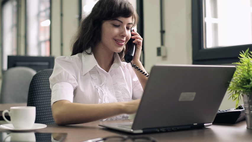Stock video of young attractive businesswoman talking on telephone ...