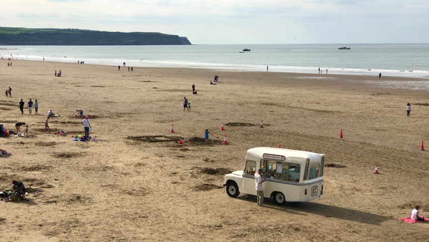 WHITBY, ENGLAND - JUNE 1: Wide Pan Shot Of Whitby Beach Packed With ...
