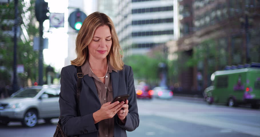 Happy Woman Holds Smartphone And Smiles On Street In City Stock Footage ...