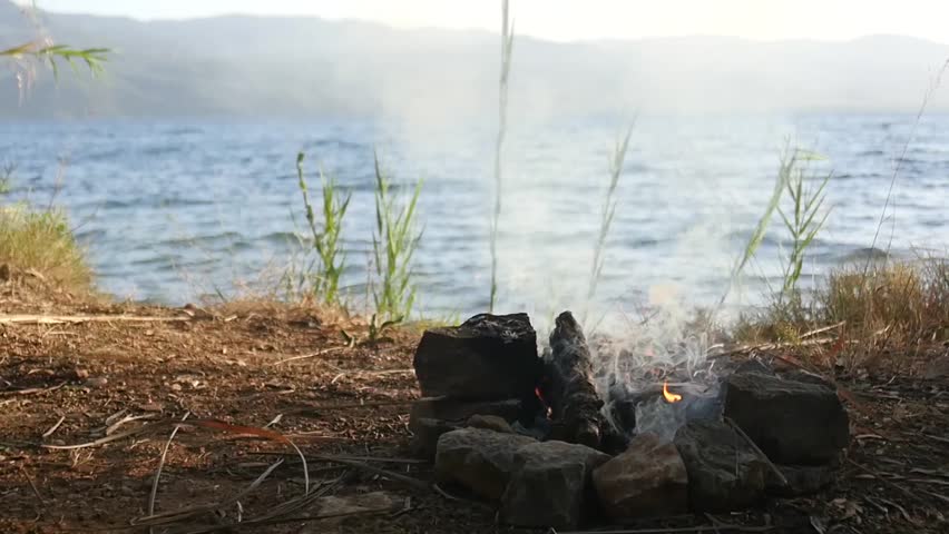 Stock Video Clip of Bonfire at the lake in Greece. Caucasian | Shutterstock
