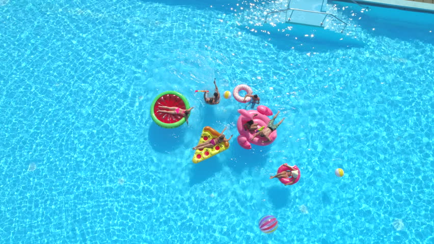 AERIAL: Cheerful Friends Having Water Gun Fight On Colorful Floaties At ...