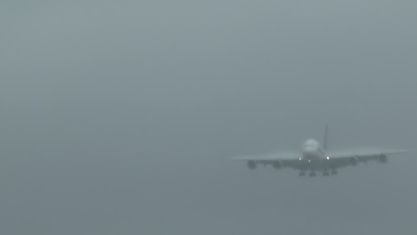 Stock Video Clip of Airplane flies through foggy storm, rain ...