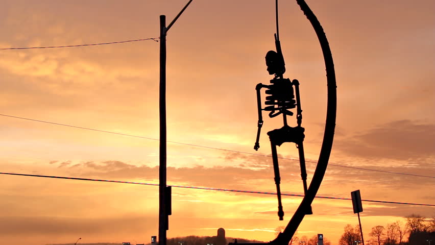 Hanging Skeleton Sunset. Rusted Metal Skeleton Silhouette Hanging From ...
