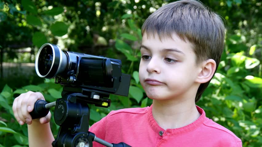 Young Girl With Video Camera Shoots Movies In Nature On Green Park Slow ...
