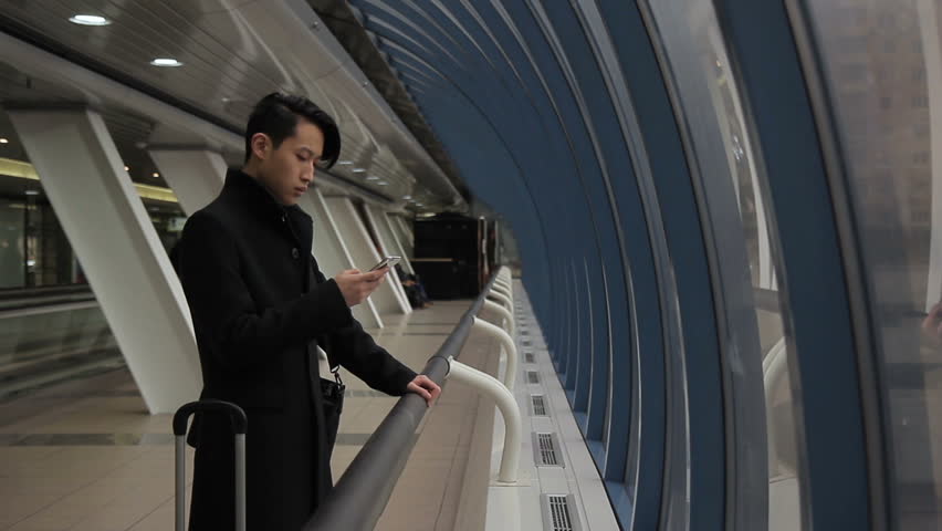 Businessman Standing With His Luggage Against Black Background Stock ...