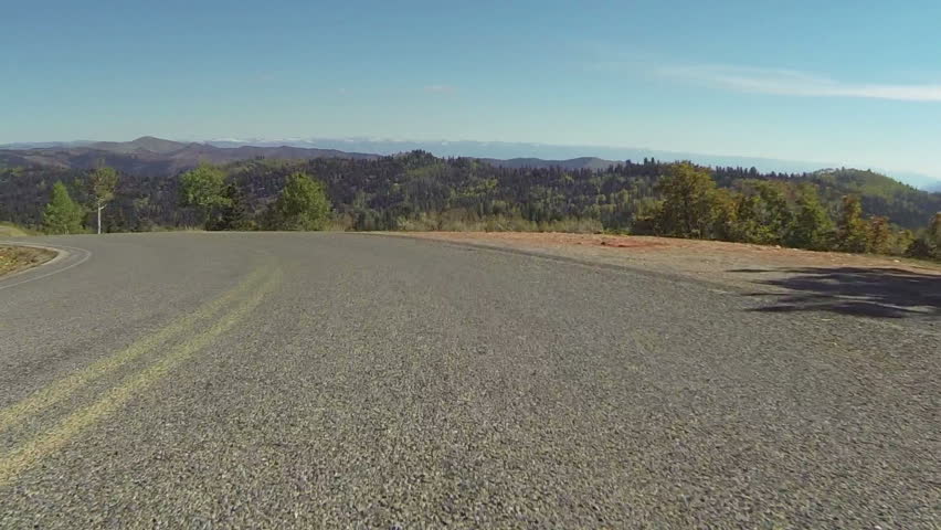Drive Down Mountain Road Low POV Forest Landscape. Vehicle Driving High ...