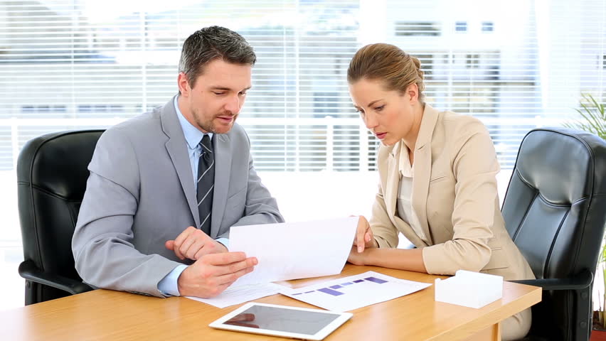Business Team Looking At Document And Giving Thumbs Up To Camera In The ...