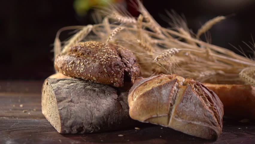 Bakery Bread On A Wooden Table. Various Bread And Sheaf Of Wheat Ears ...