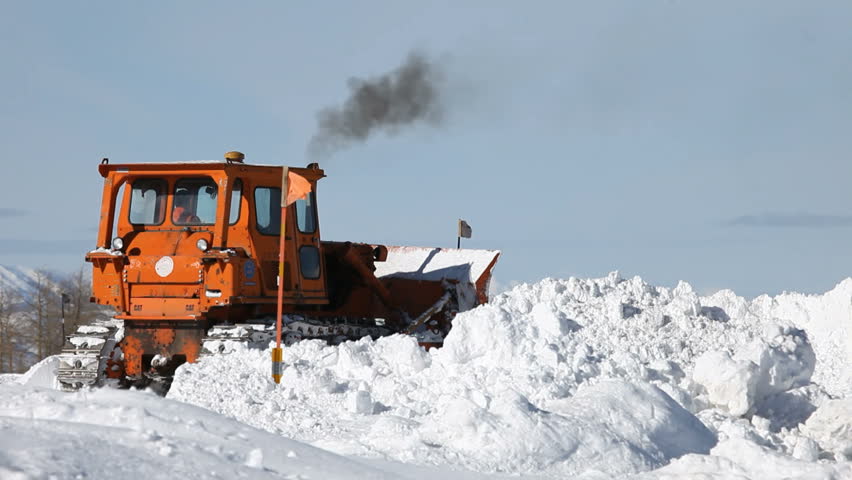 Bulldozer Pushing Deep Snow Off Mountain Road Near Forest In Central ...