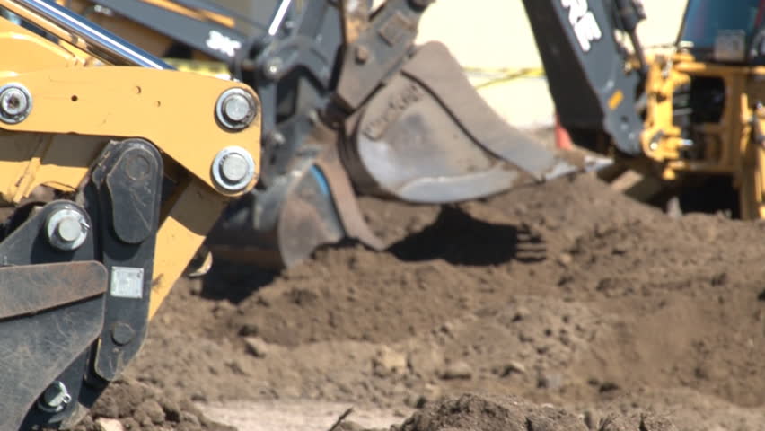 Backhoes Digging and Dumping Foreground Stock Footage Video (100% ...