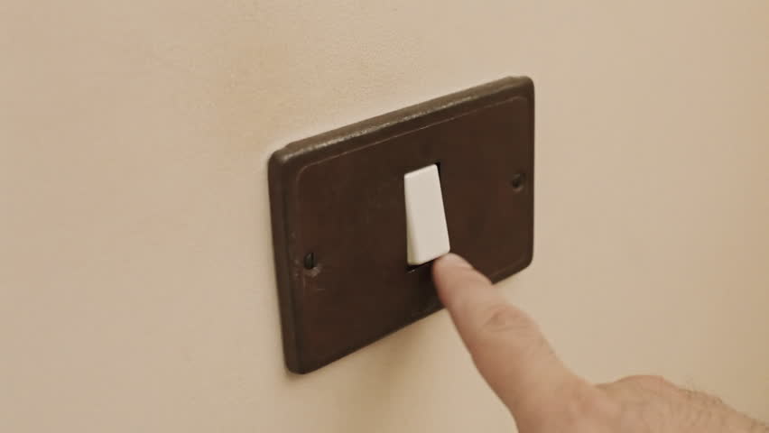 A Man's Hand Flips A Light Switch On, And Then Turns It Off, Again And ...