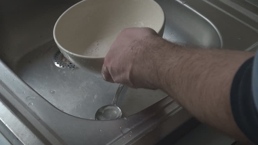 Working Water Tap In A Kitchen. Water Flows Into A Glass Bowl With A ...