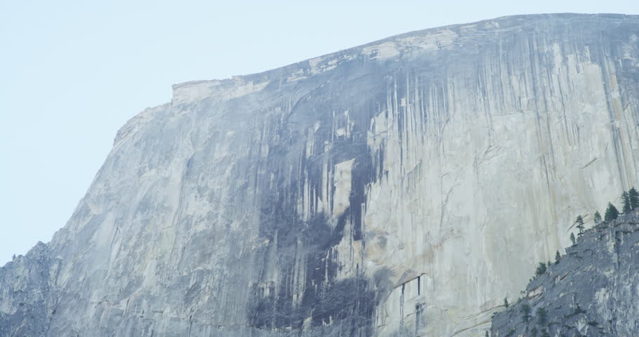 White Snow Rocky Mountain Cliff. A View Of A Sheer Rock Cliff Covered ...