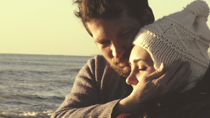 Stock video of couple cuddling while snowing on beach | 9018220 ...