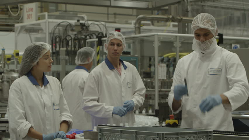 4K Production Facility Team Staff Together On Factory Floor. Smiling ...