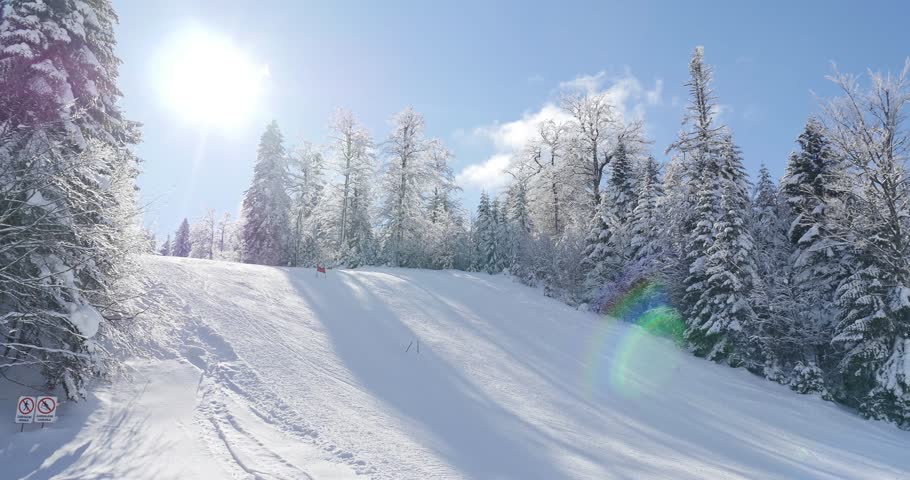A 4K Shot Of A Beautiful Winter Scene With Some Skiers Skiing Downhill ...