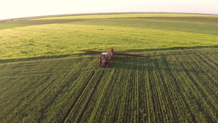 Drone Flight Aerial Bird Eye View Of Tractor Mowing Grass From Side Of ...